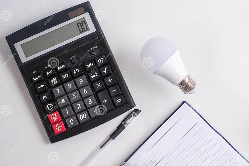 Saving Electricity. on a White Background is a Calculator Light Bulb and a Notebook Stock Photo ...