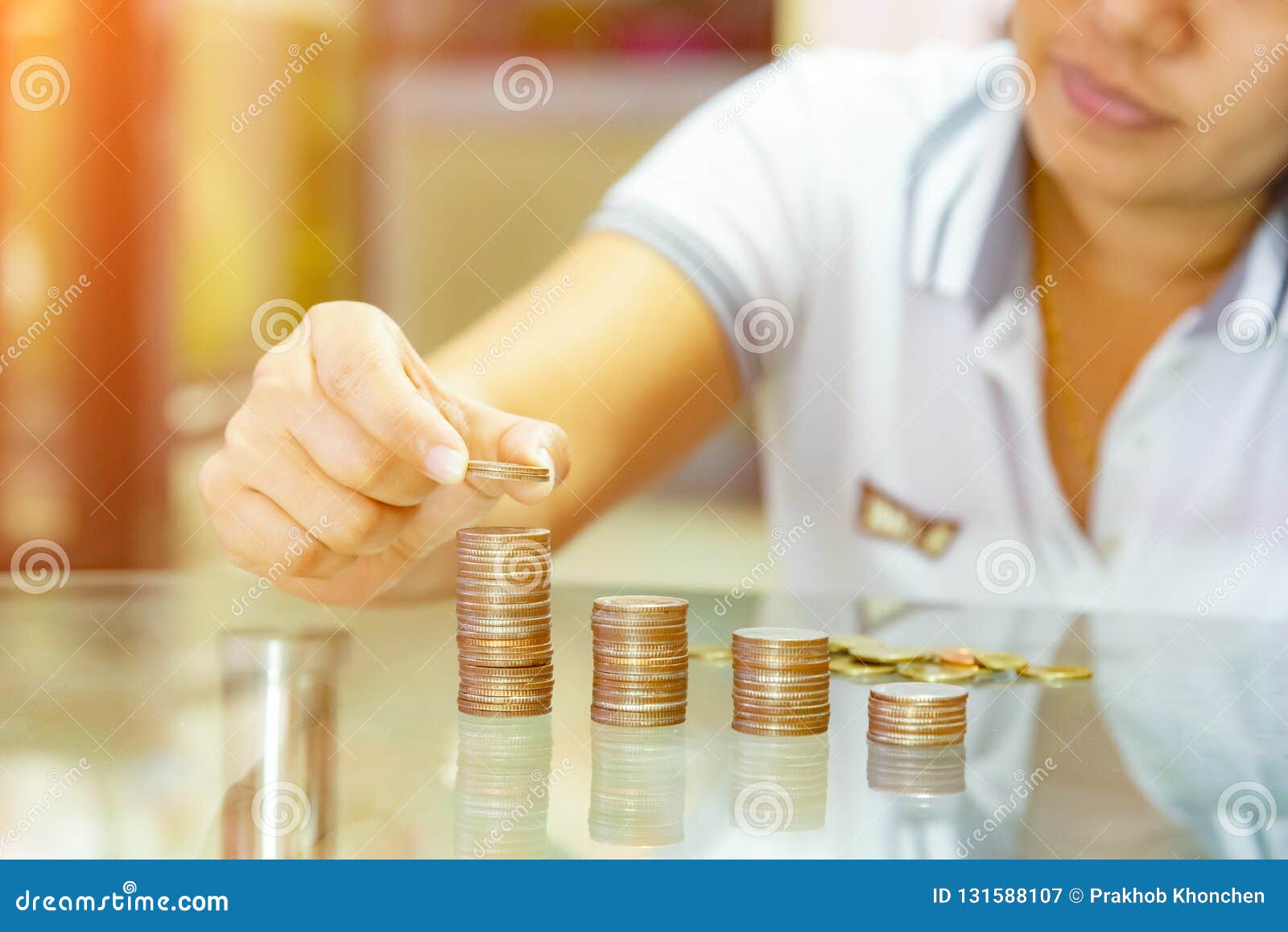 Saving Money Concepts, Woman Stacking Coins into Increasing Columns ...