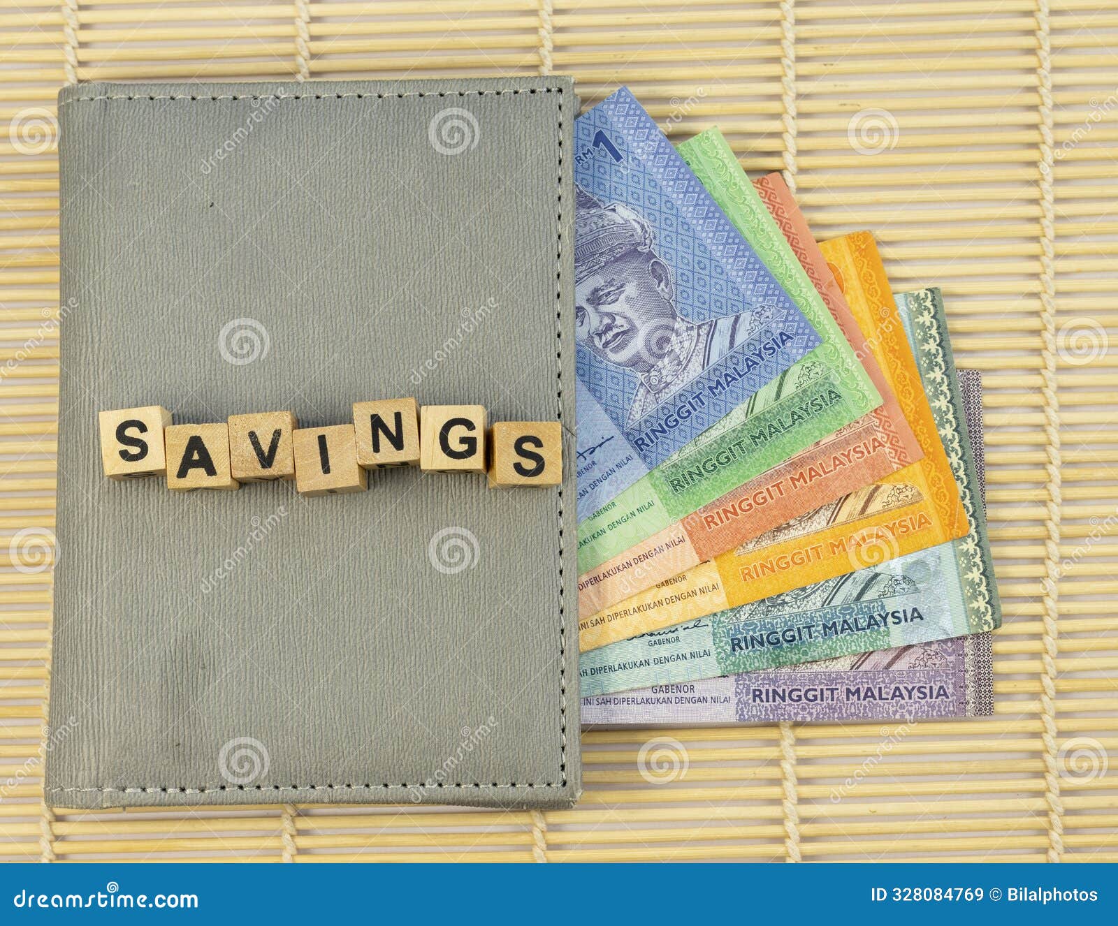 SAVINGS Text on a Wooden Blocks Cubes on a Wallet Full with Malaysian ...