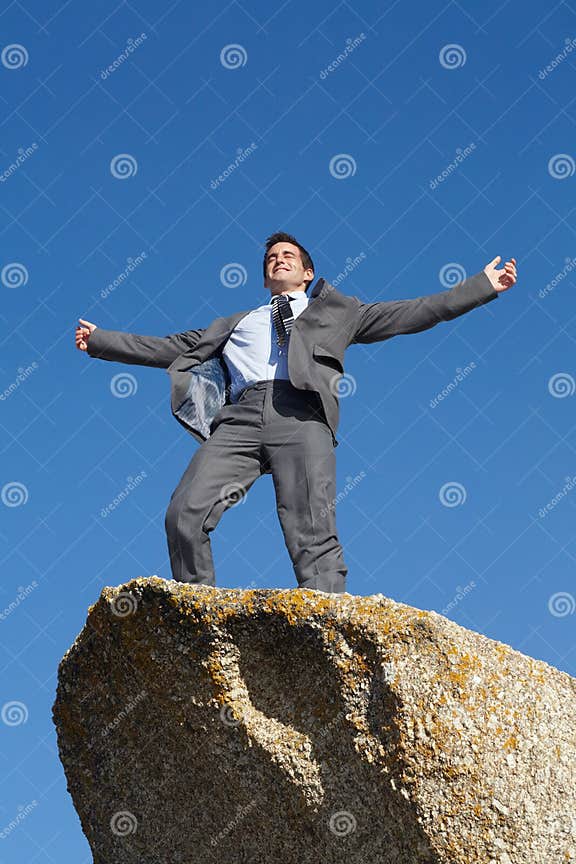 Savouring a Moment at the Top. a Young Businessman Standing with His ... Savouring a Moment at the Top. a Young Businessman Standing with His ...