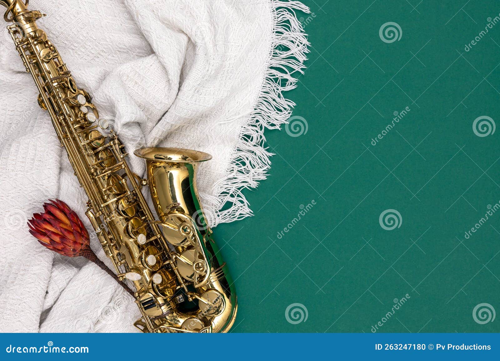 Saxophone on a Green Background with a Blanket and a Flower, Top View ...