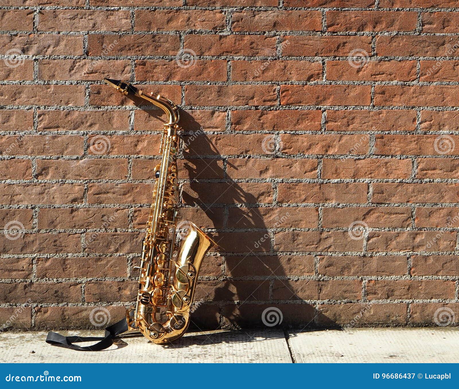 Saxophone Leaning Against a Red Brick Wall Stock Image - Image of brass ...