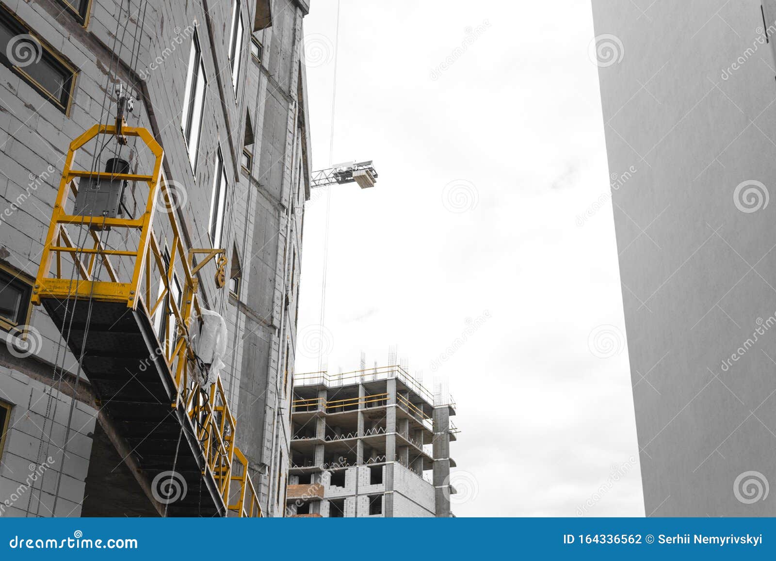 Scaffold Elevator Hanging on Building Under Construction with Gray Sky ...