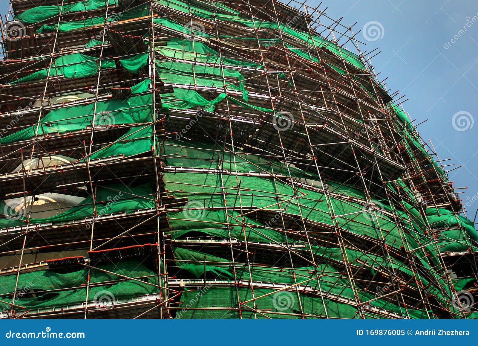 Scaffolding at a Construction Site, Facade Covered with Green Mesh ...