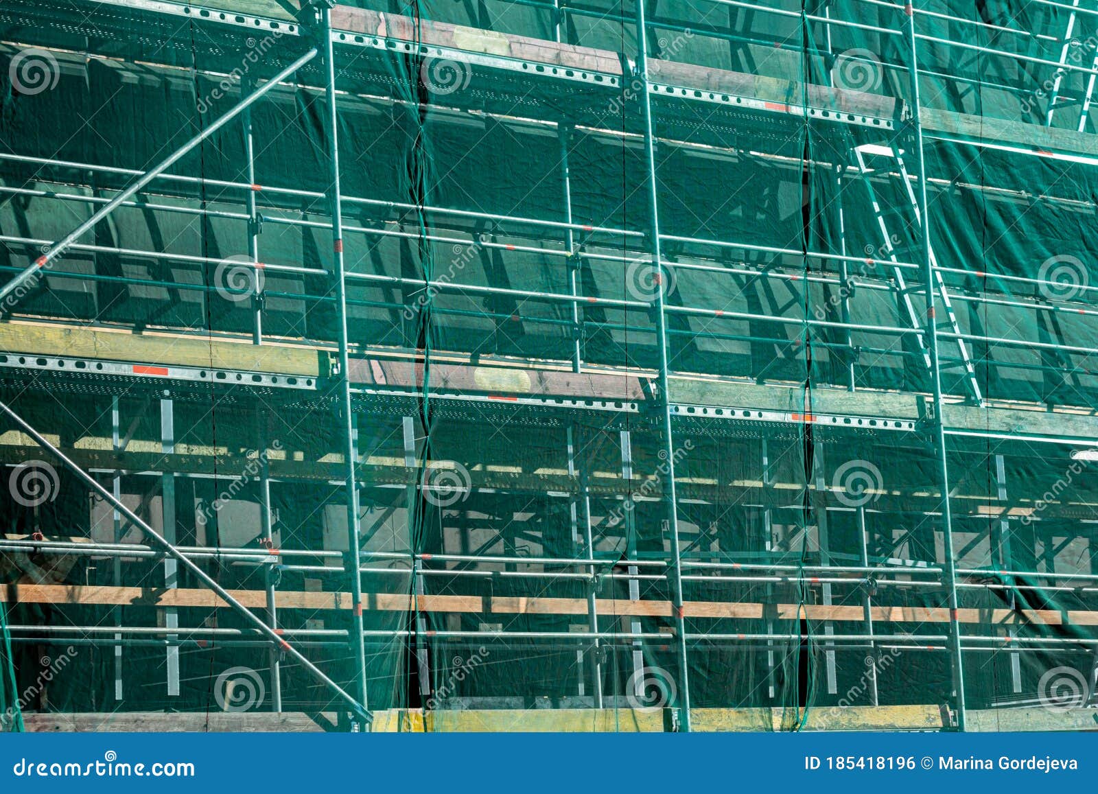 Scaffolding Covered in Green Mesh. Construction or Repair Work Stock ...