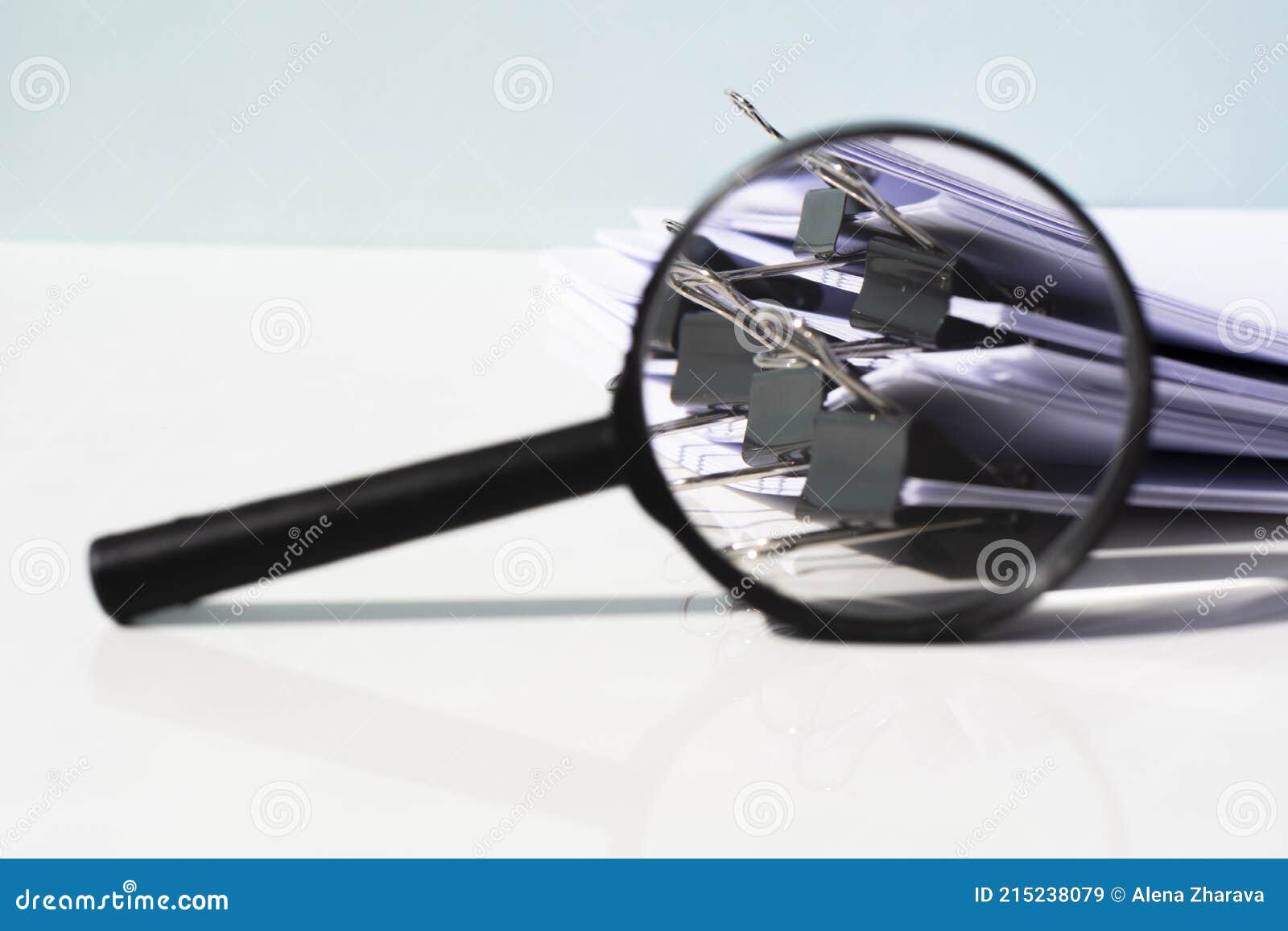 Scanning Business Documents. Magnifying Glass on the Stack of Documents ...