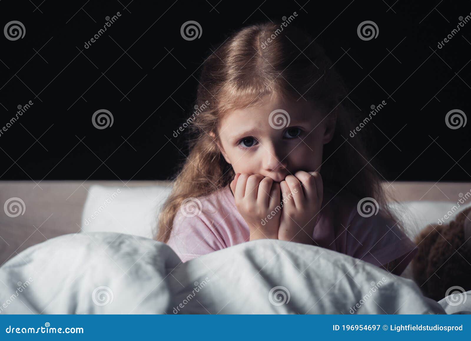 Scared Child Looking at Camera while Sitting on Bedding Stock Image ...