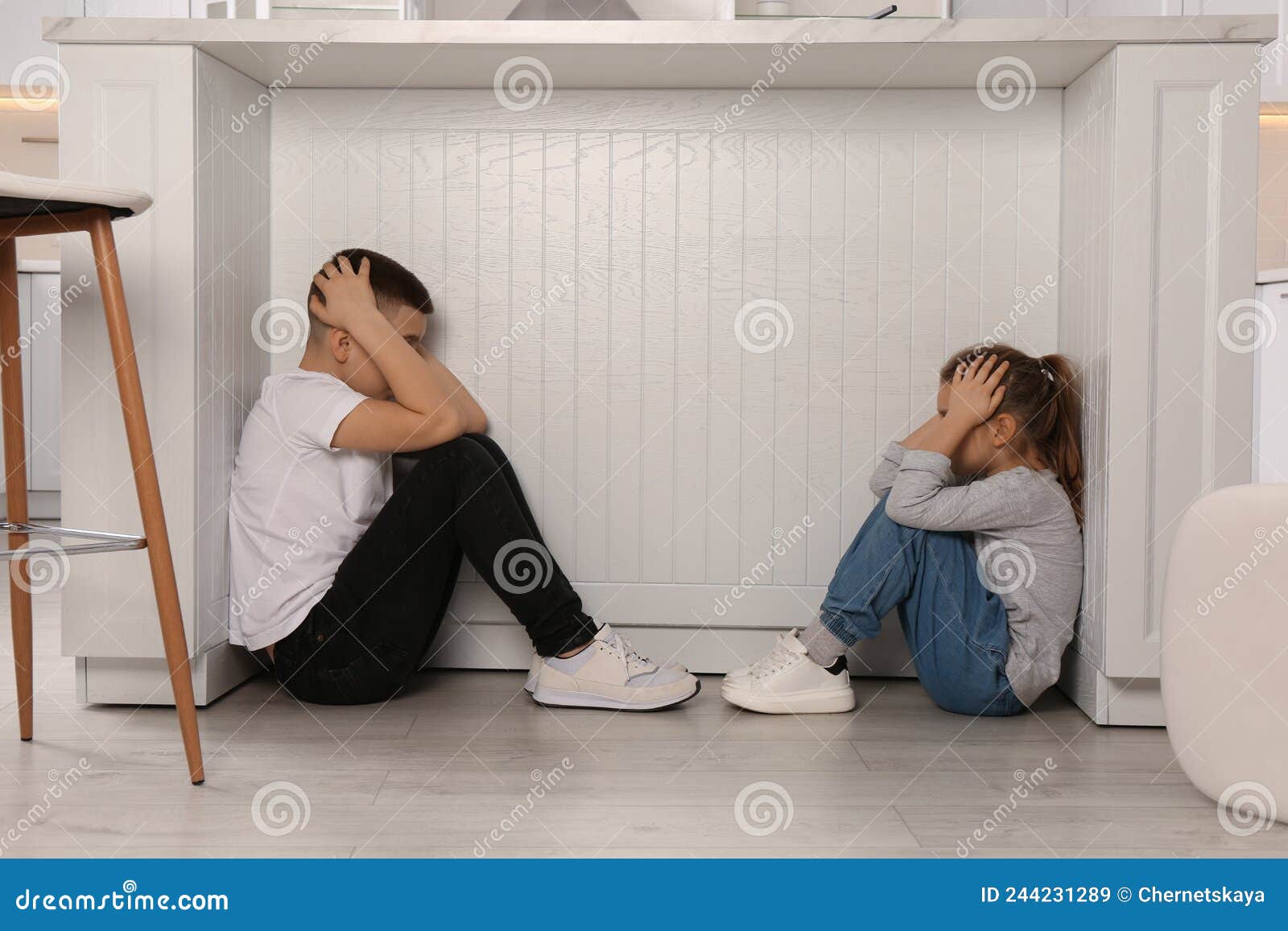 Scared Children Hiding Under Table in Kitchen during Earthquake Stock ...
