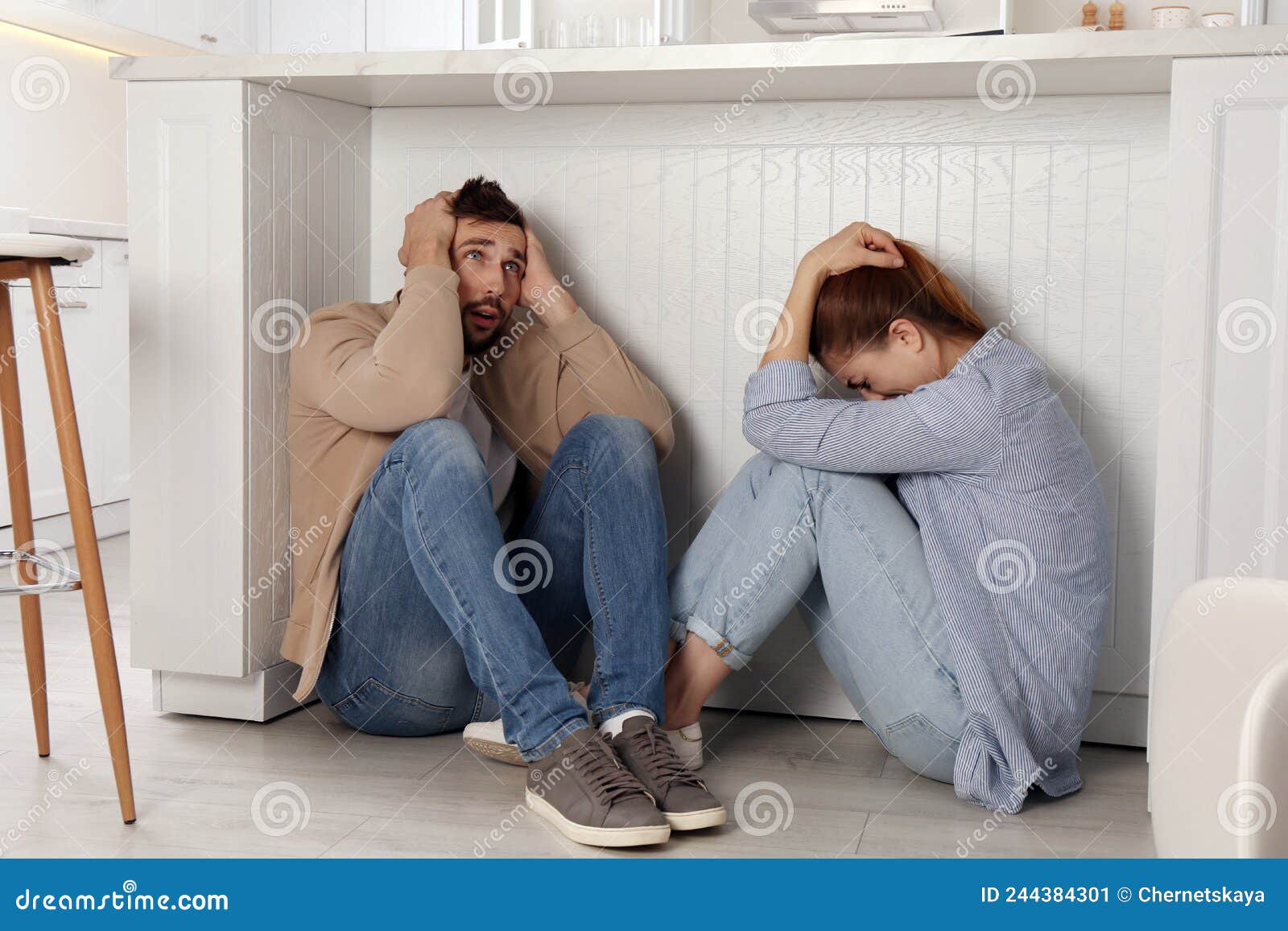 Scared Couple Hiding Under Table in Kitchen during Earthquake Stock ...