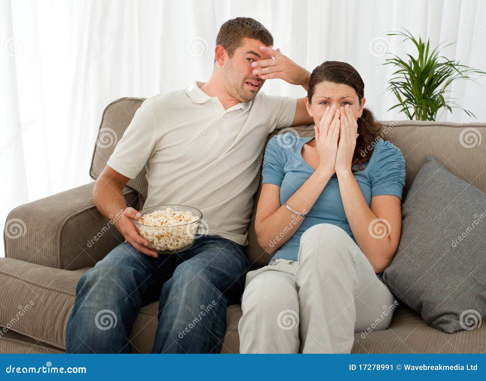 Scared Couple On Sofa Watching TV Together Royalty-Free Stock Image ...
