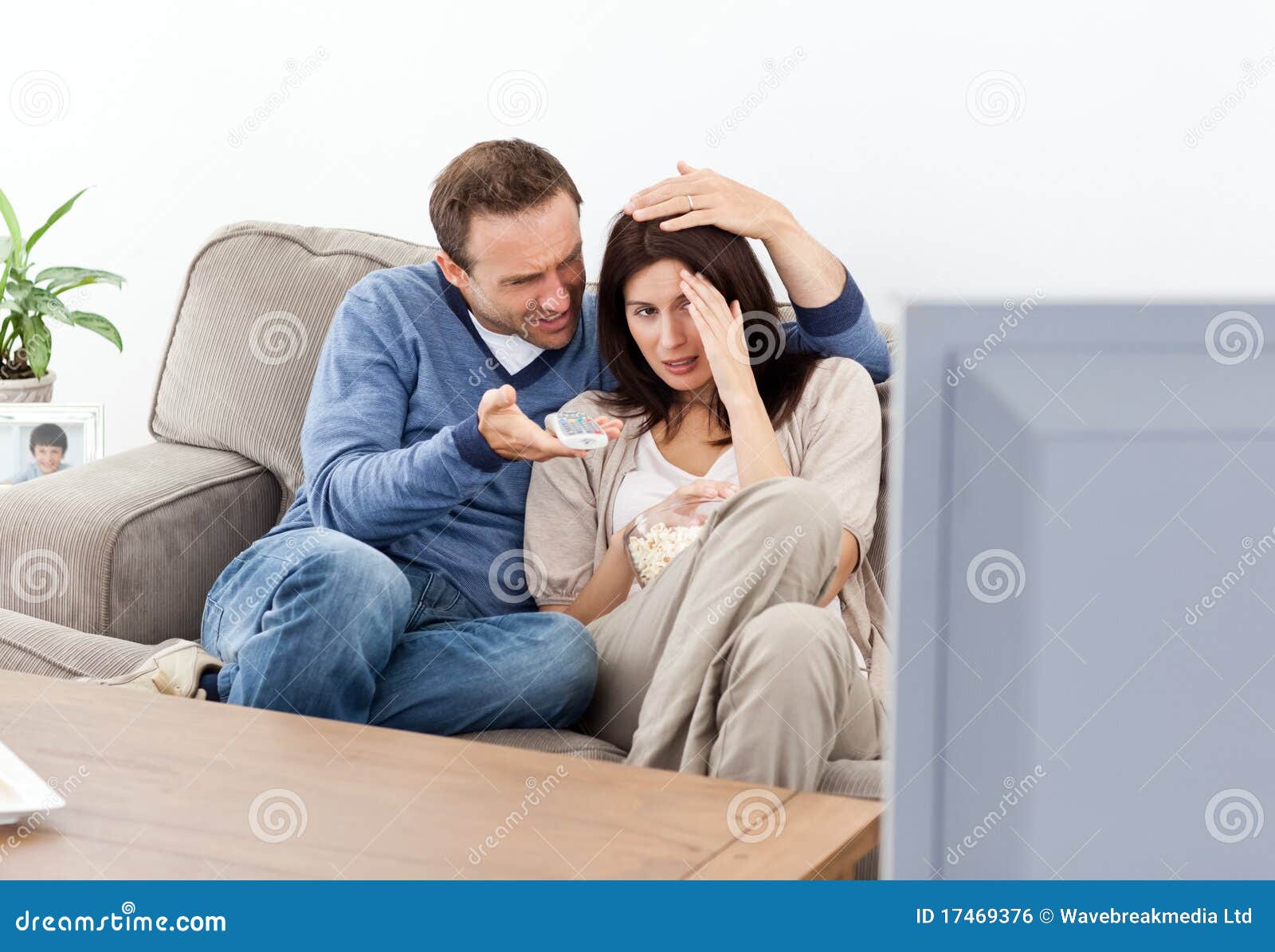Scared Couple Watching a Horror Movie Stock Photo - Image of couch ...
