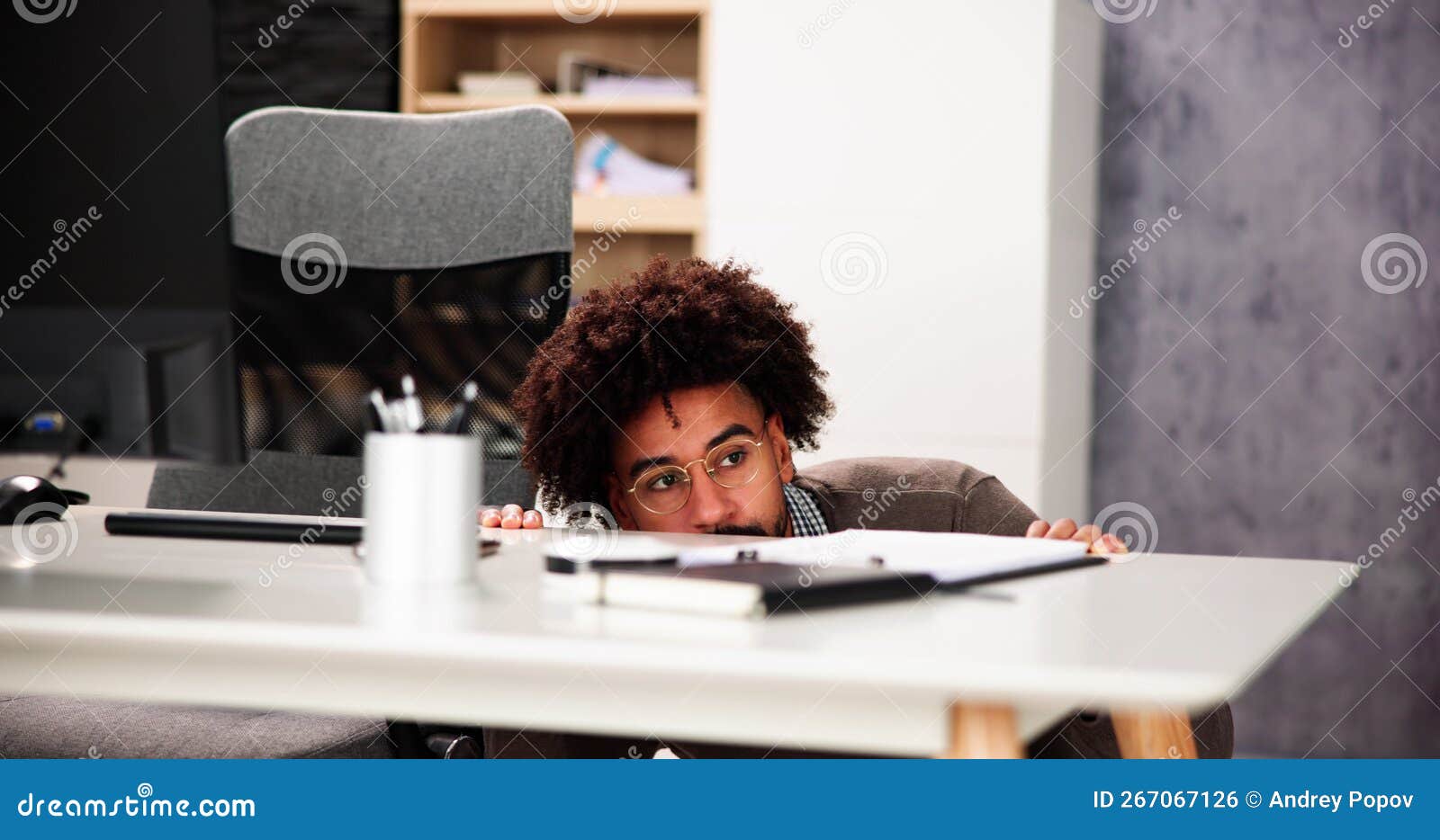 Scared Man Hiding Behind Office Desk Stock Photo - Image of looking ...