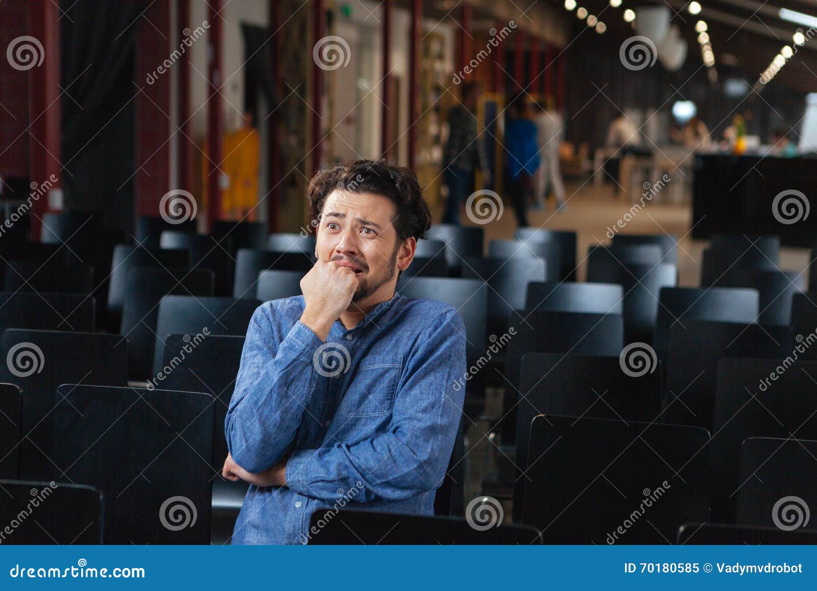 Scared Man Sitting in Conference Hall Stock Image - Image of hall, hand ...
