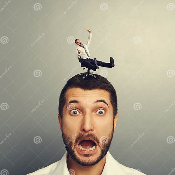 Scared Man with Small Crazy Man on the Head Stock Photo - Image of ...