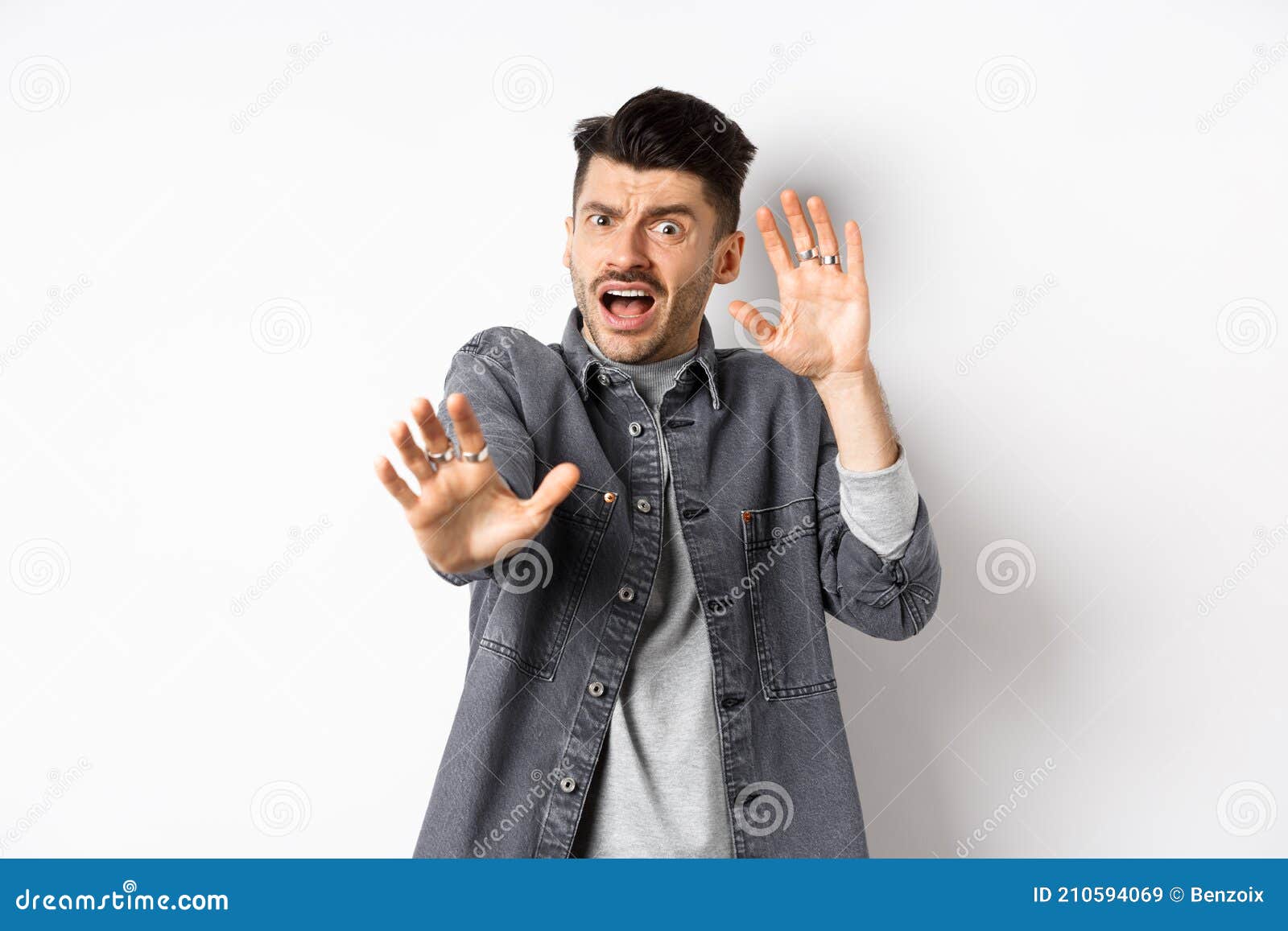 Scared Timid Guy Screaming and Raising Hands in Pleading Pose, Begging ...