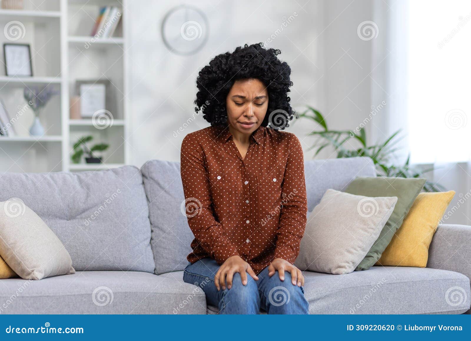Scared and Upset Young Woman Sitting Sad on Sofa at Home, Suffering ...
