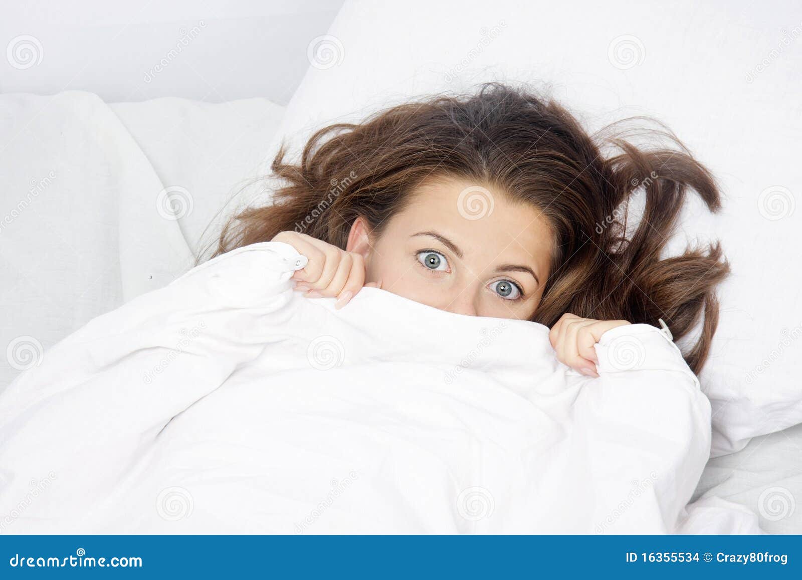 Scared woman in bed stock photo. Image of horror, adult - 16355534