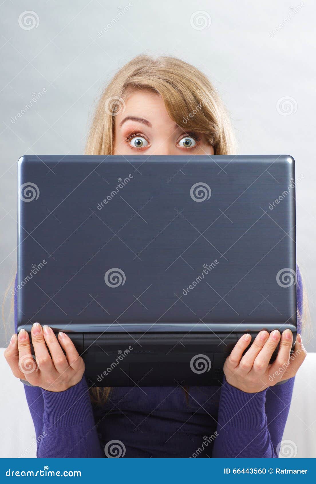 Scared Woman Holding Laptop and Looking Out from Behind Computer Stock ...