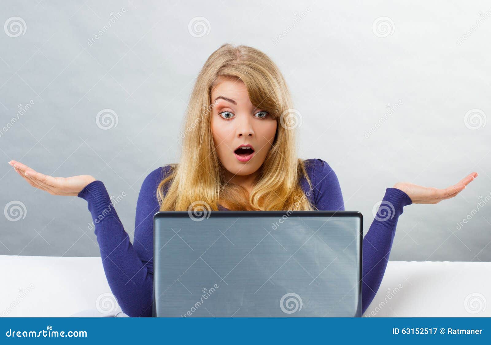 Scared Woman Shrugging Shoulders and Looking at Laptop, Computer ...