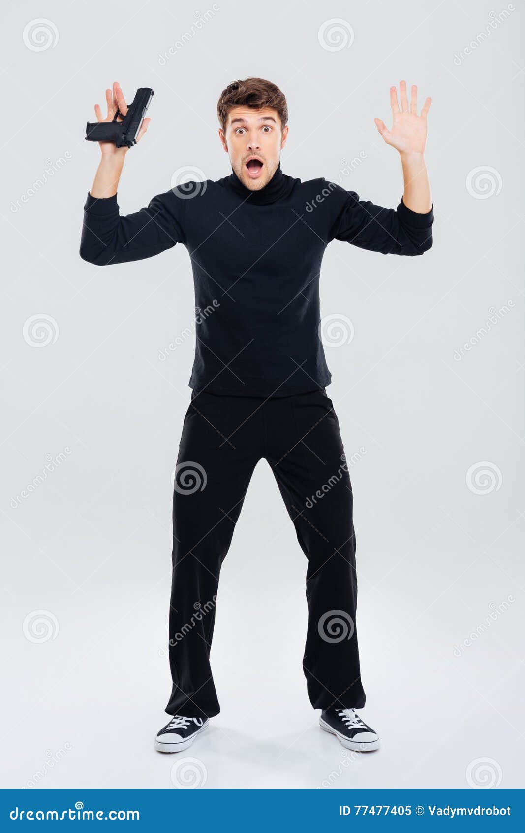 Scared Young Man Holding Gun and Standing with Hands Up Stock Image ...