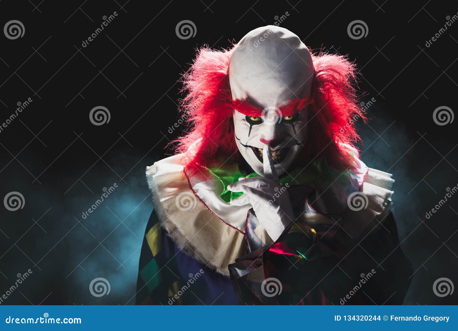 Scary Clown Joker With A Smile And Red Hair With A Big Knife On Stock ...