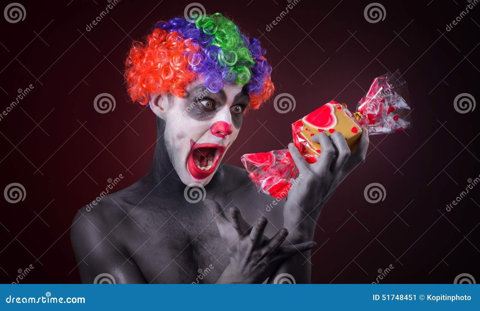 Scary Clown with Spooky Makeup and More Candy Stock Image - Image of ...