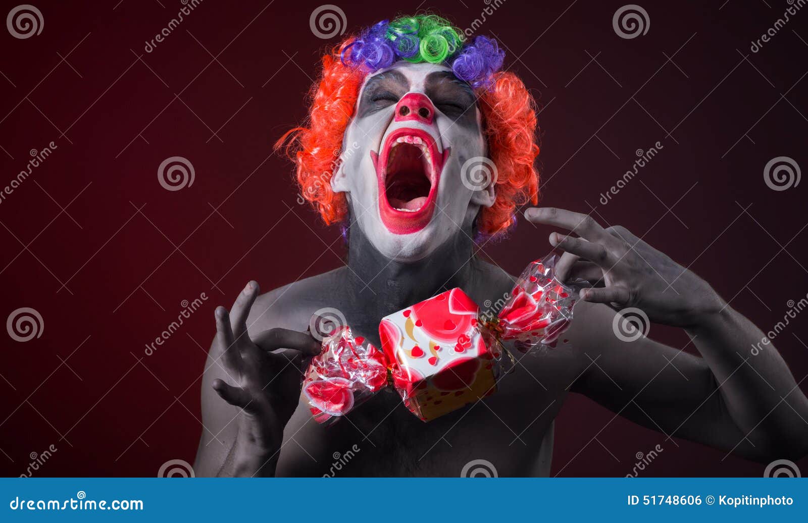 Scary Clown with Spooky Makeup and More Candy Stock Photo - Image of ...