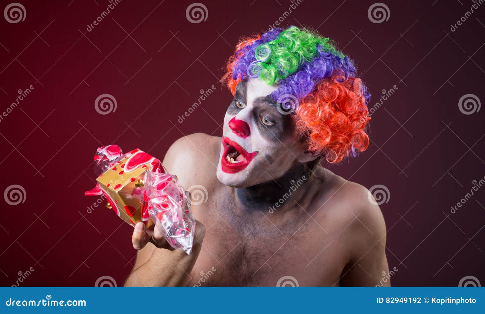 Scary Clown with Spooky Makeup and More Candy Stock Photo - Image of ...