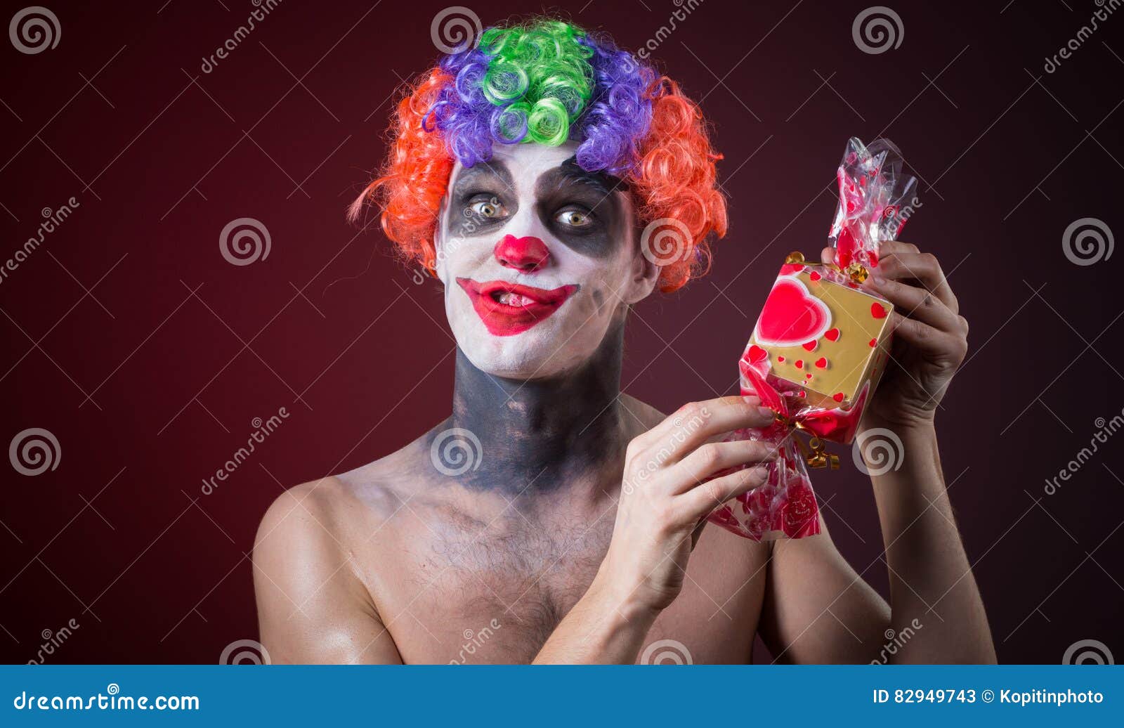 Scary Clown with Spooky Makeup and More Candy Stock Image - Image of ...