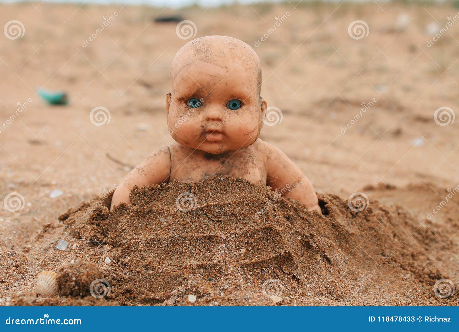 Scary doll in the sand stock image. Image of demonic - 118478433