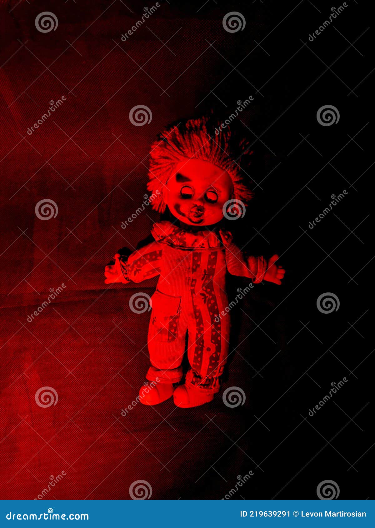 Scary and Old Battered Clown Doll with Burnt Face Under Red and Black ...