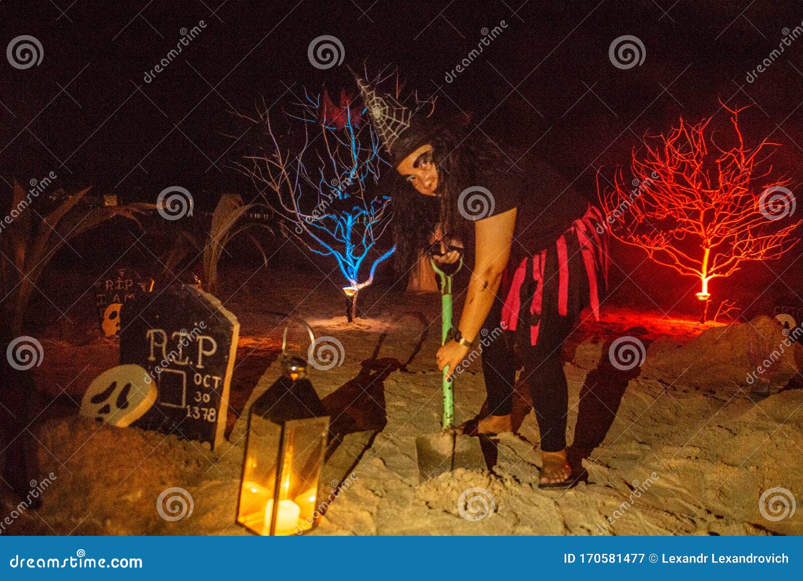 Scary Witch Digging Grave during Halloween Party at the Artificial ...