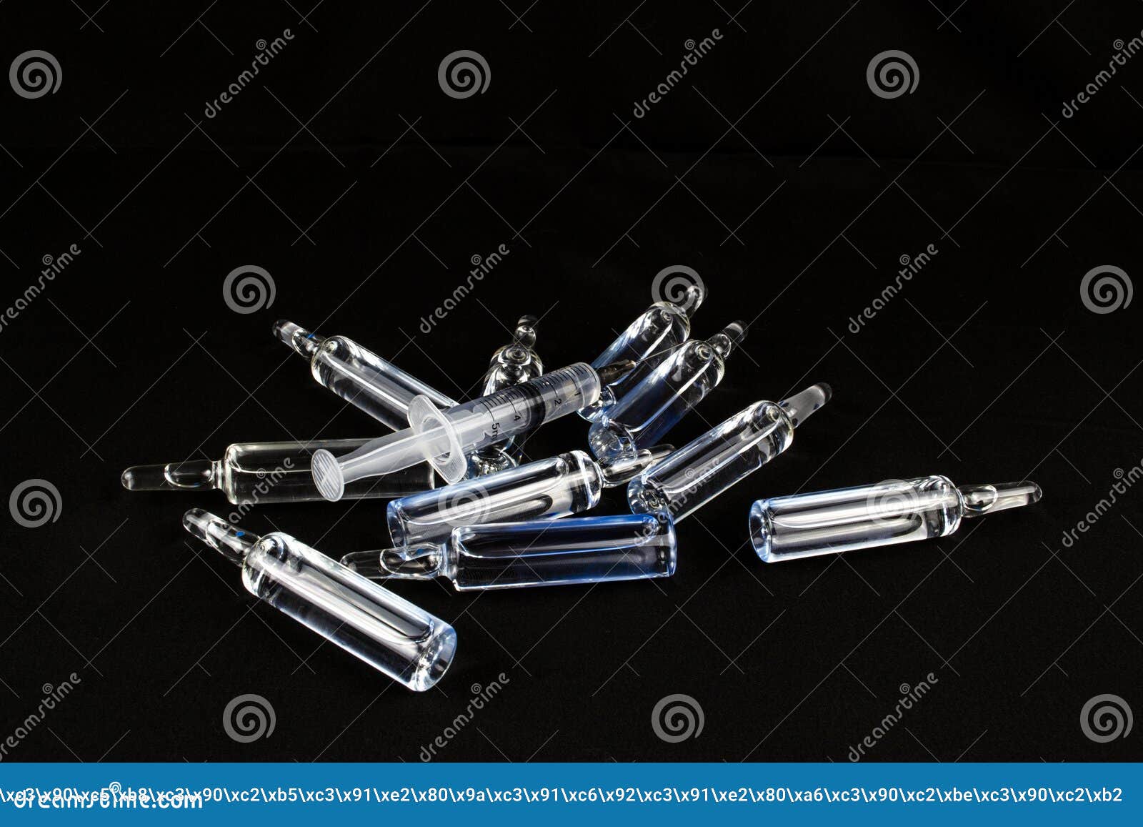 Scattered Ampoules with a Solution with a Syringe and a Needle on a ...