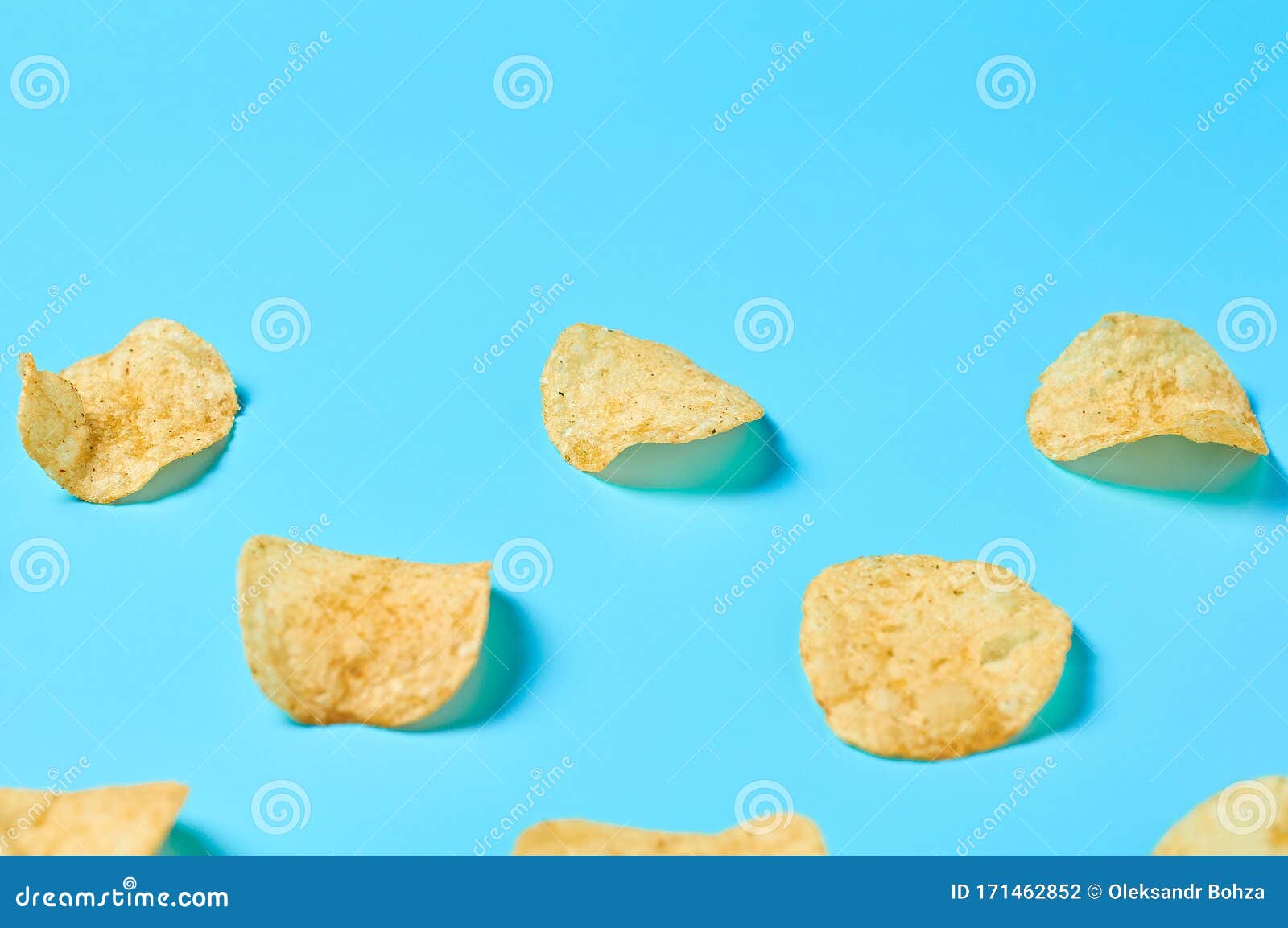 Scattered Fried Potato Chips on Blue Background Stock Photo - Image of ...