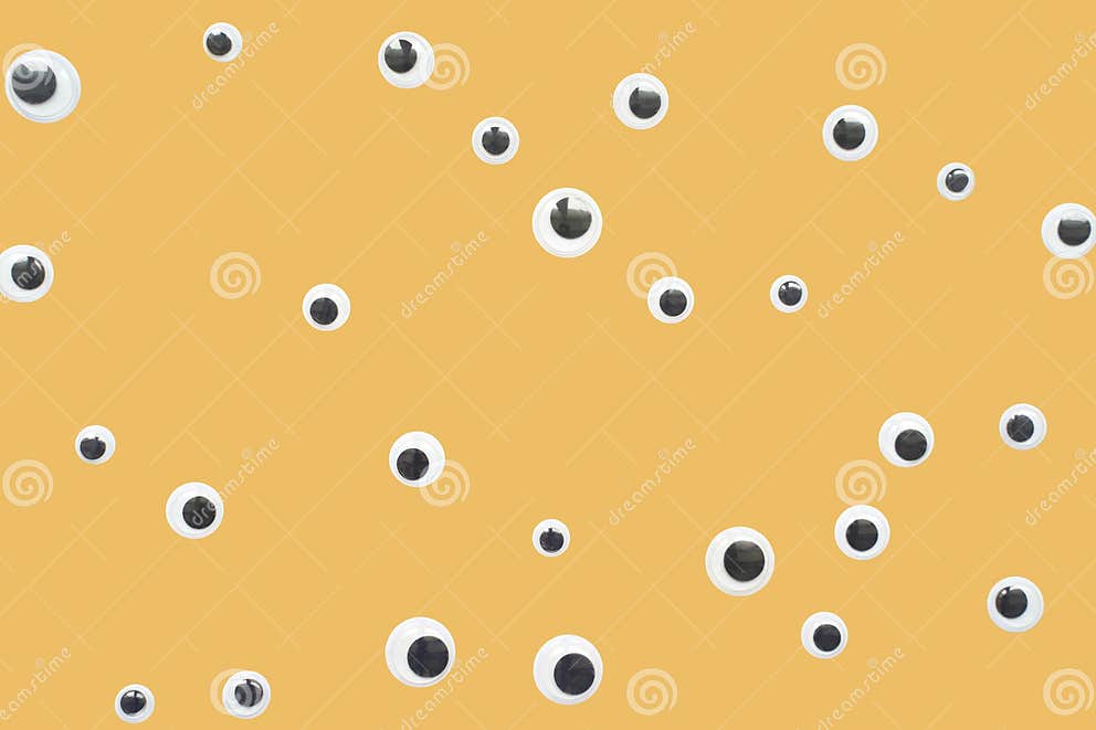 Scattered Googly Eyes on Yellow Background with Playful and Creative ...