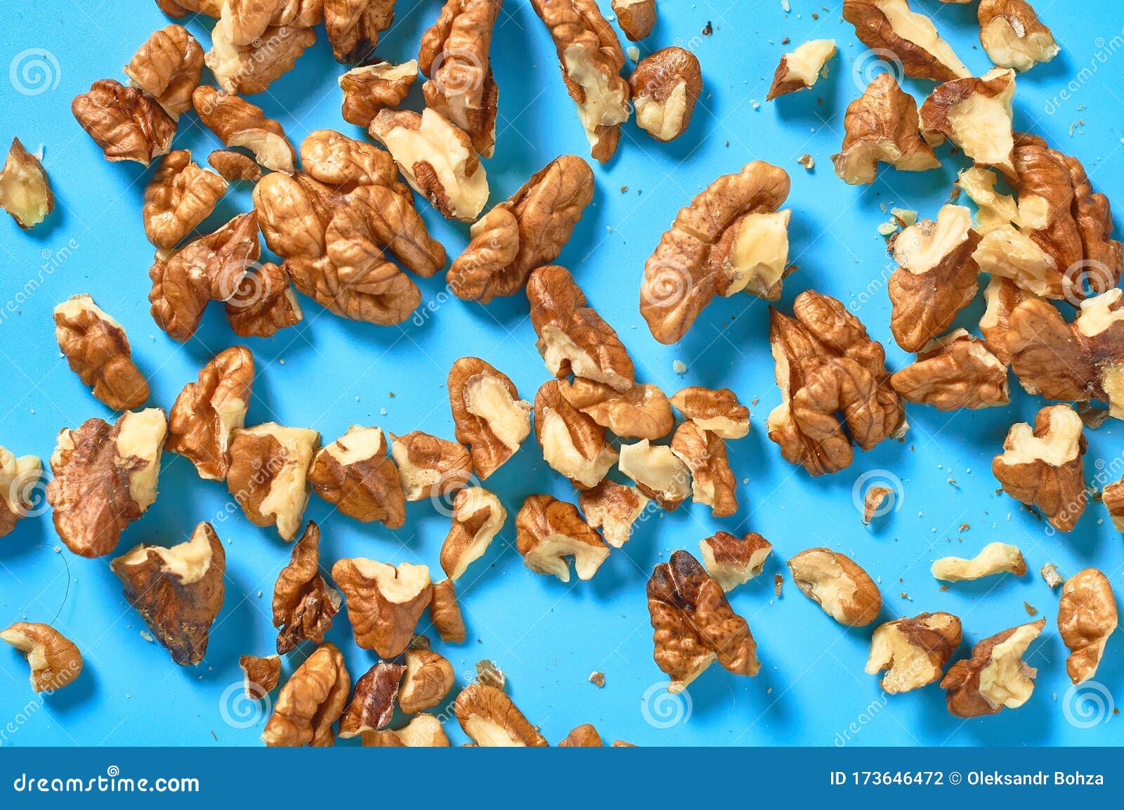 Scattered Pieces of Pulp and Whole Walnut on Blue Background Stock ...