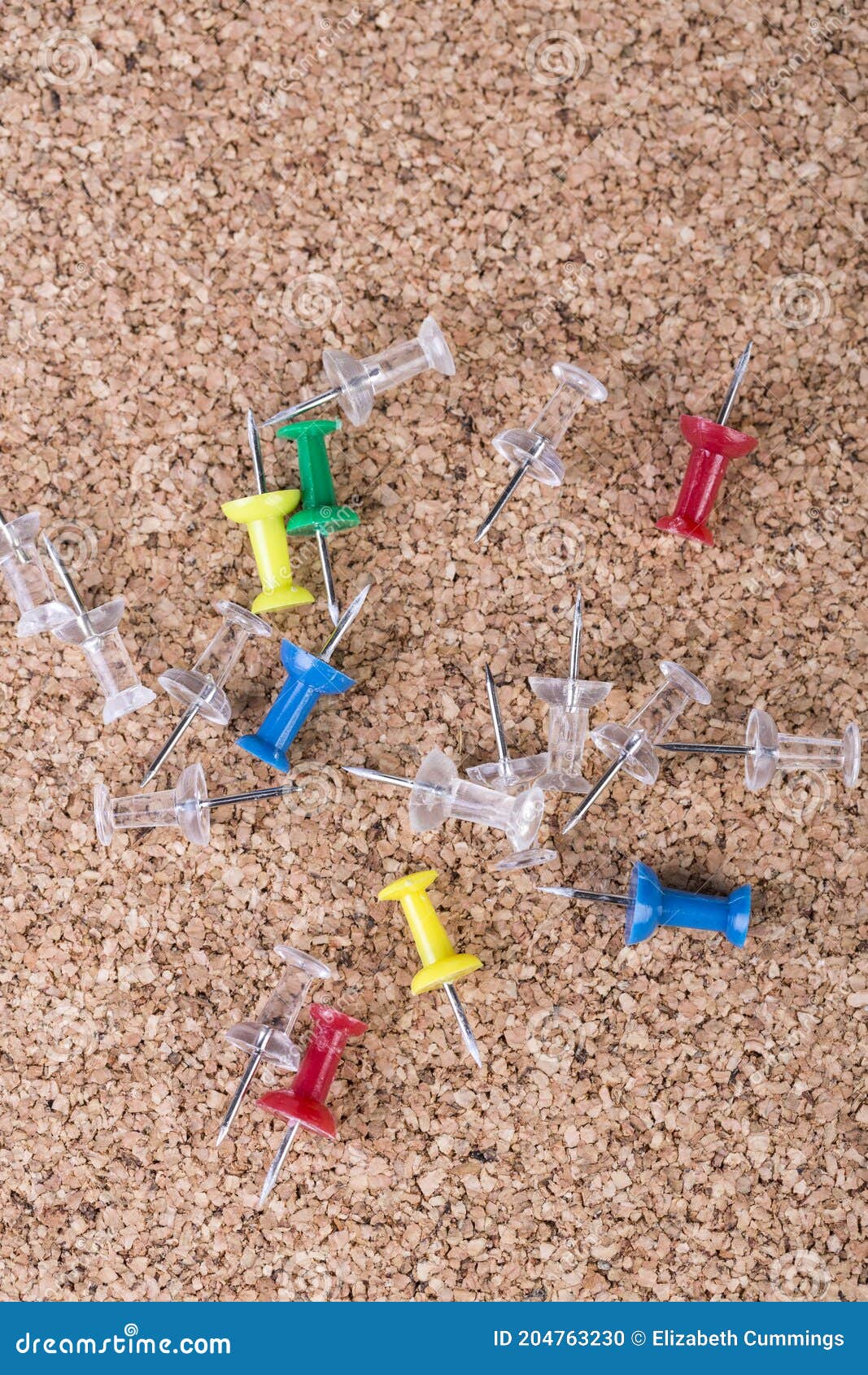 Scattered Pile of Multicolored Thumb Tacks on a Brown Cork Board Stock ...