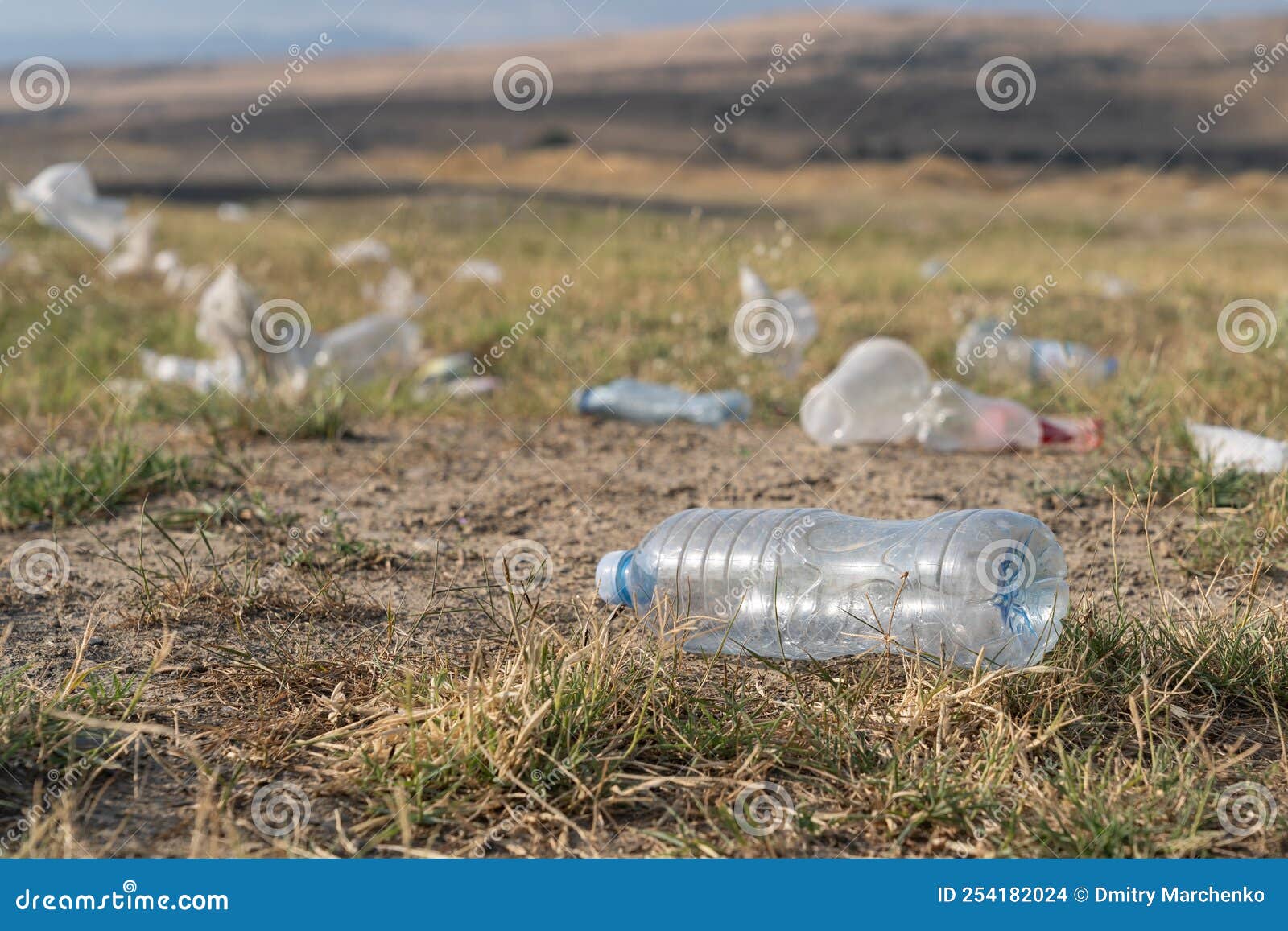 Scattered Plastic Bottles and Bags Lie on Grass in Rural Area Causing ...