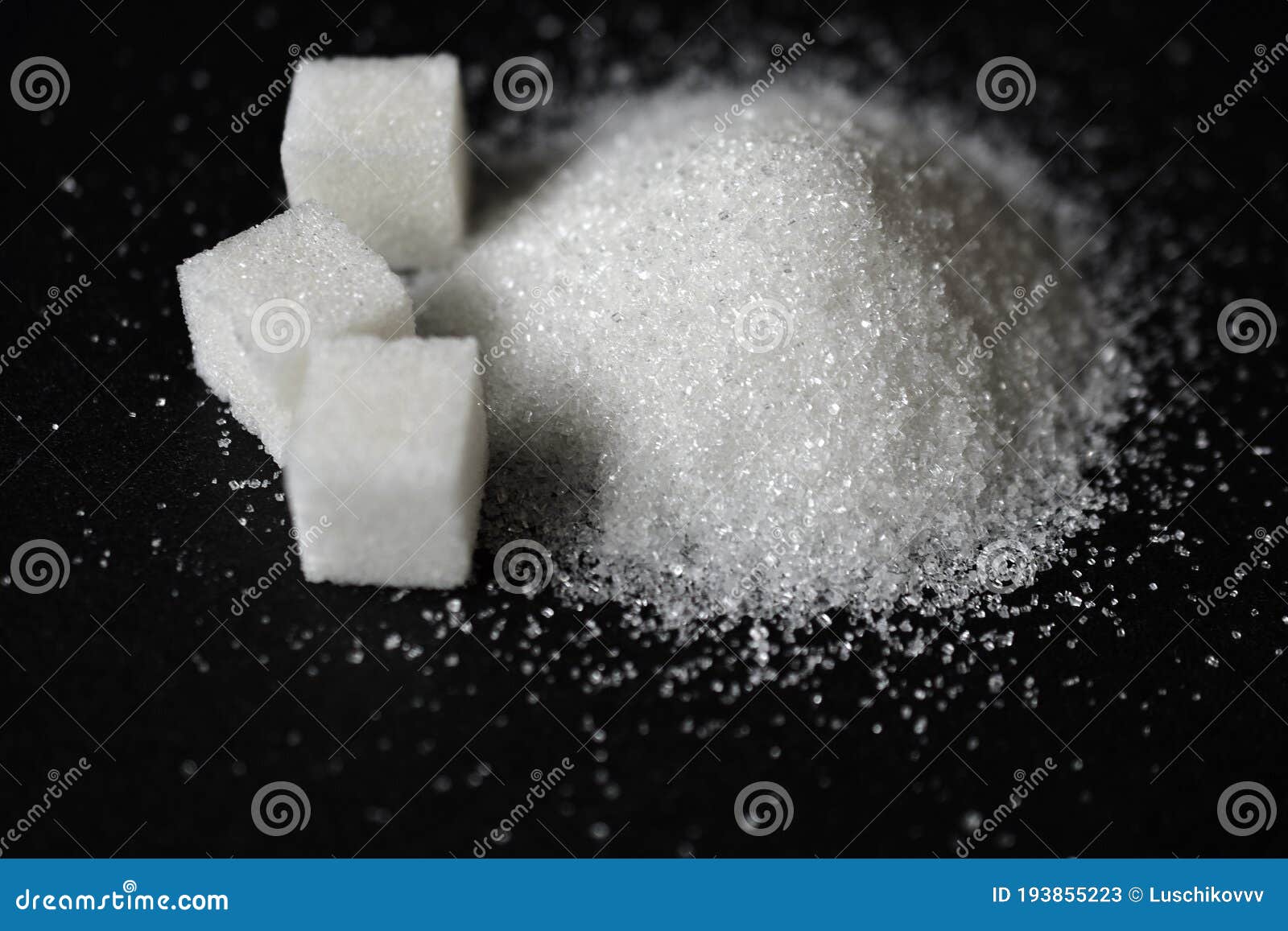 Scattered Sugar in a Pile and Refined Sugar Cubes on a Black Background ...