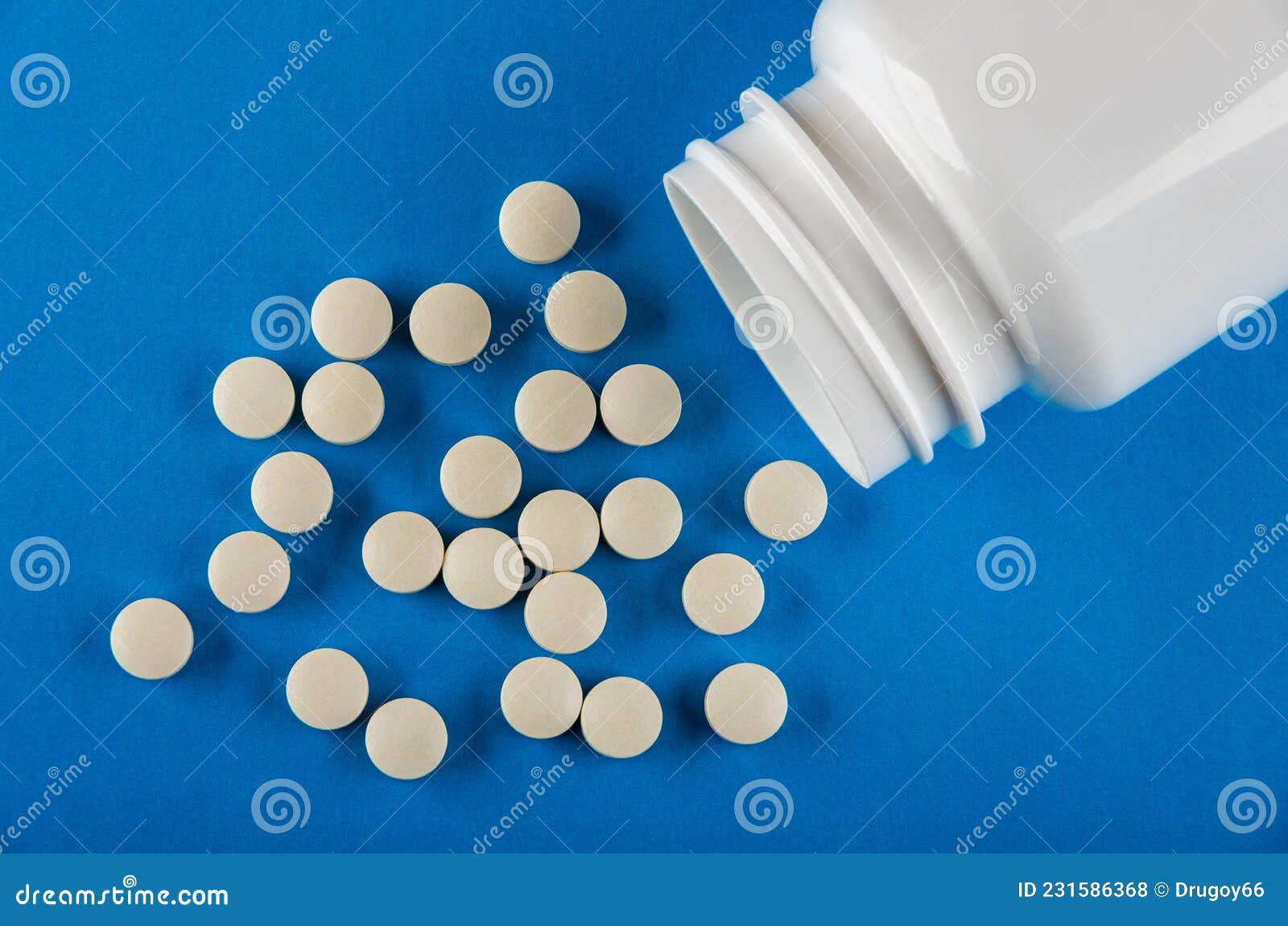 Scattered White Round Tablets, Opened Jar on Blue Table. Top View Stock ...