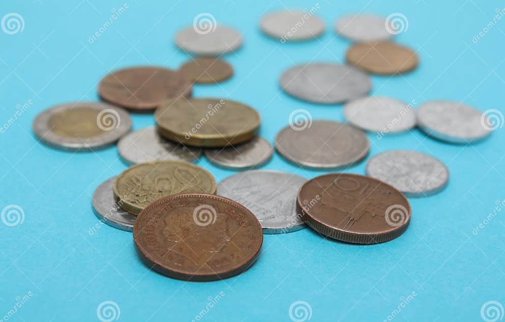 A Scattering of Coins on the Blue Background Stock Photo - Image of ...
