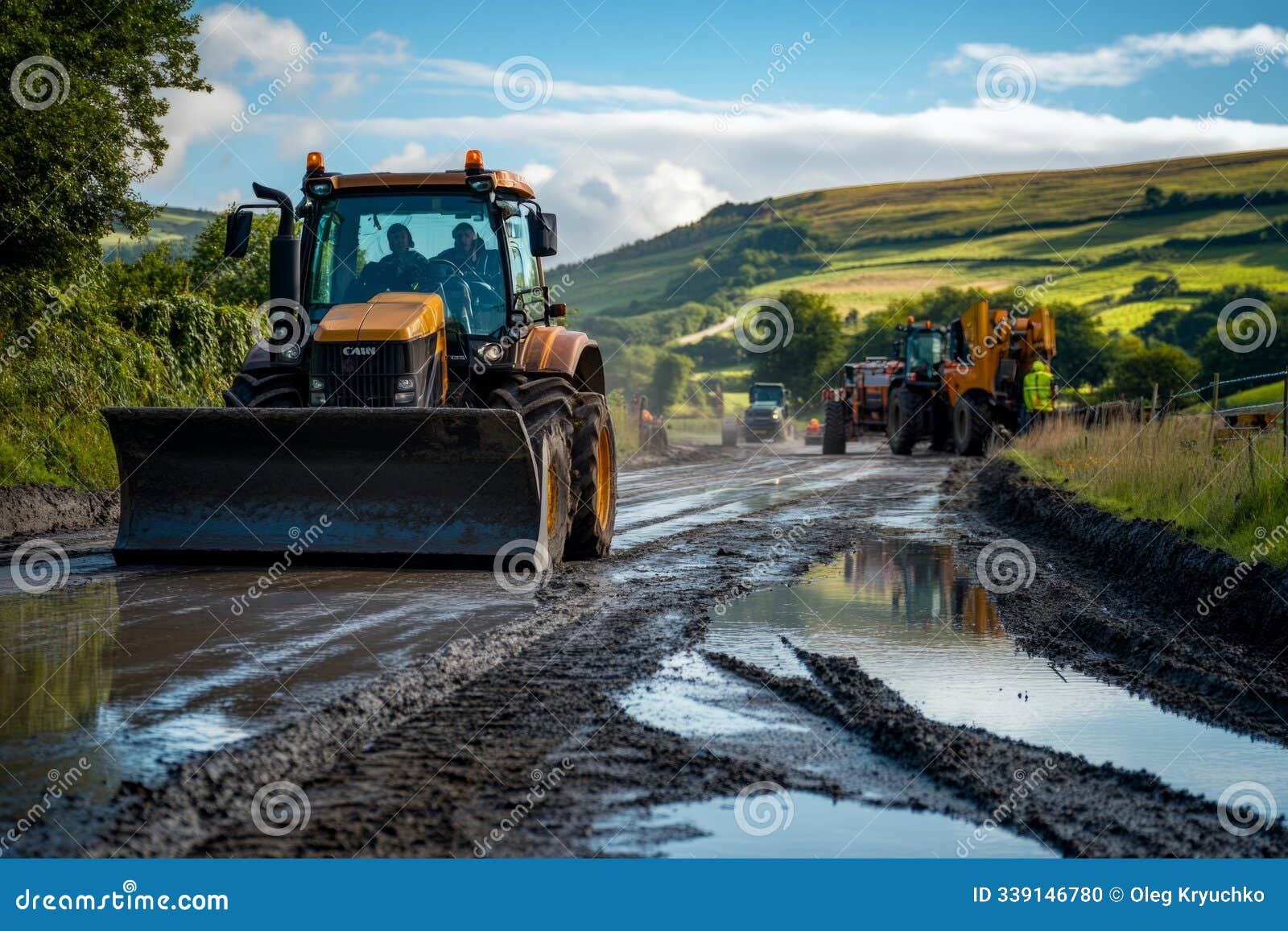 Heavy Machinery Working on a Muddy Road. Earth Movers Reshape the ...