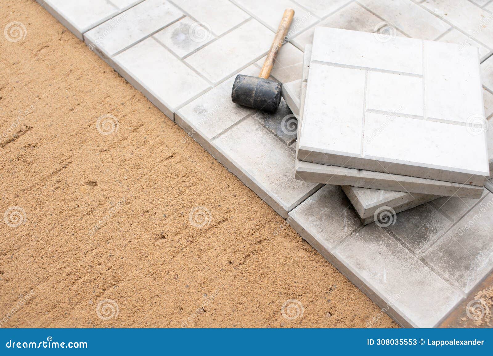 Scene of an Ongoing Pavement or Tile Installation. There is a Rubber ...