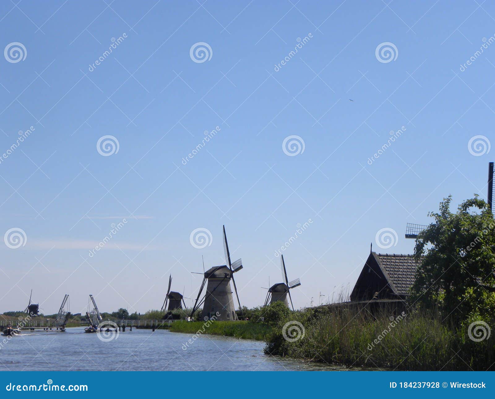 Scenery of Mills Near a River on a Blue Clear Sky Background Stock ...