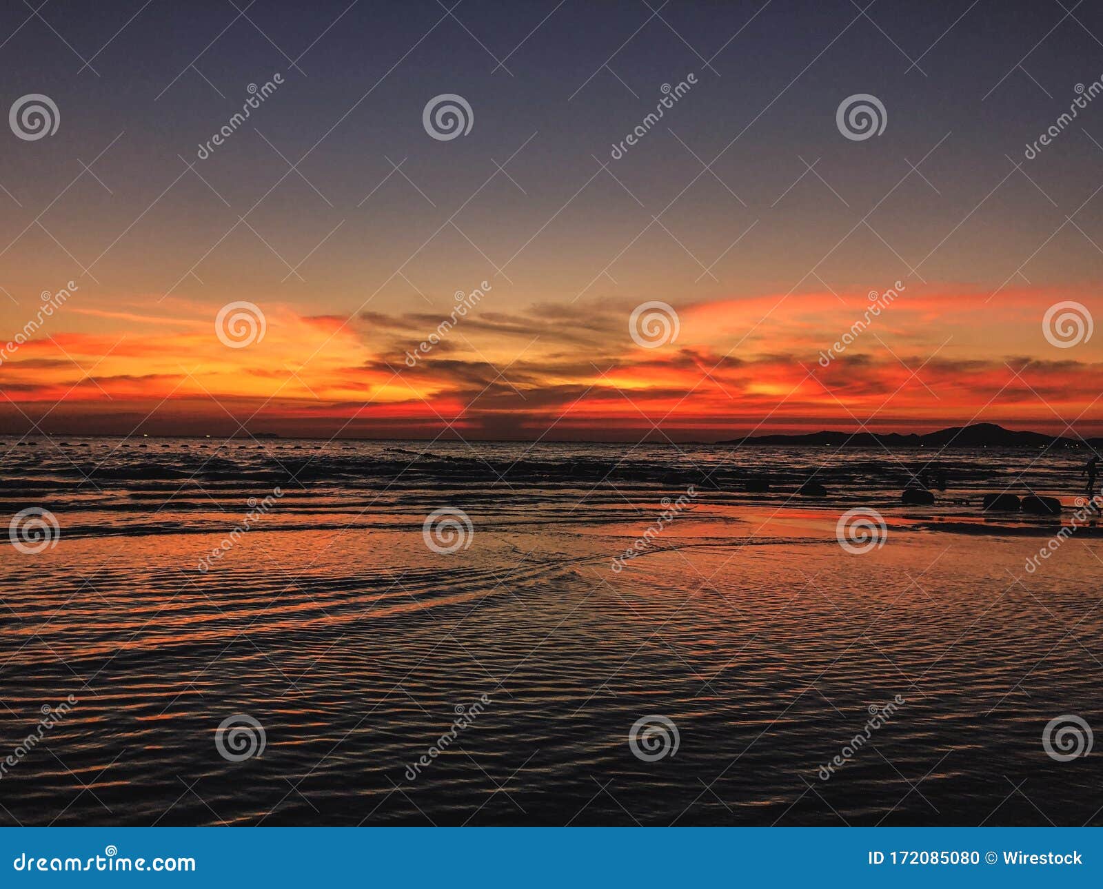 Scenery of Sunset on the Beach with Calming Waves of the Ocean Stock ...