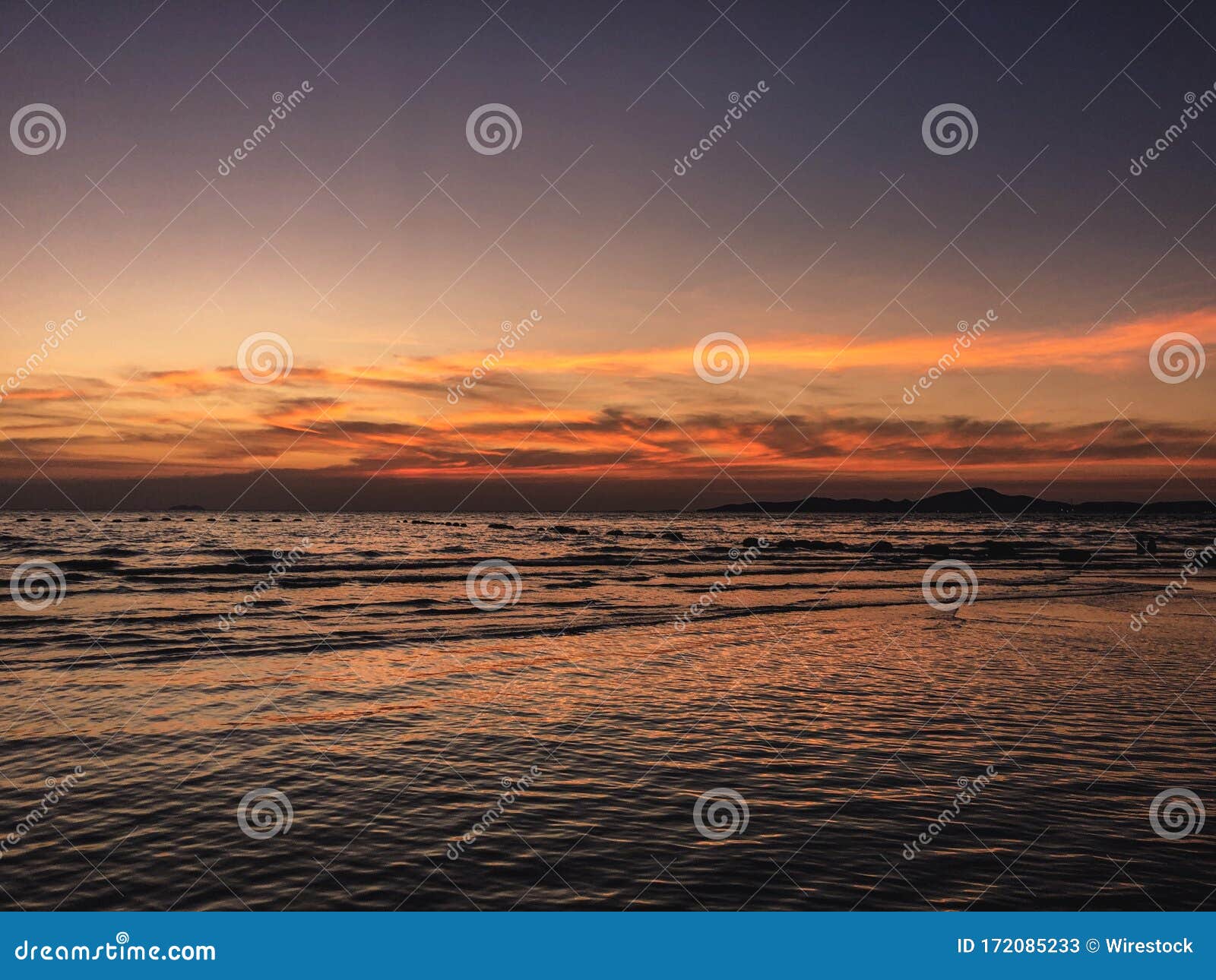 Scenery of Sunset on the Beach with Calming Waves of the Ocean Stock ...