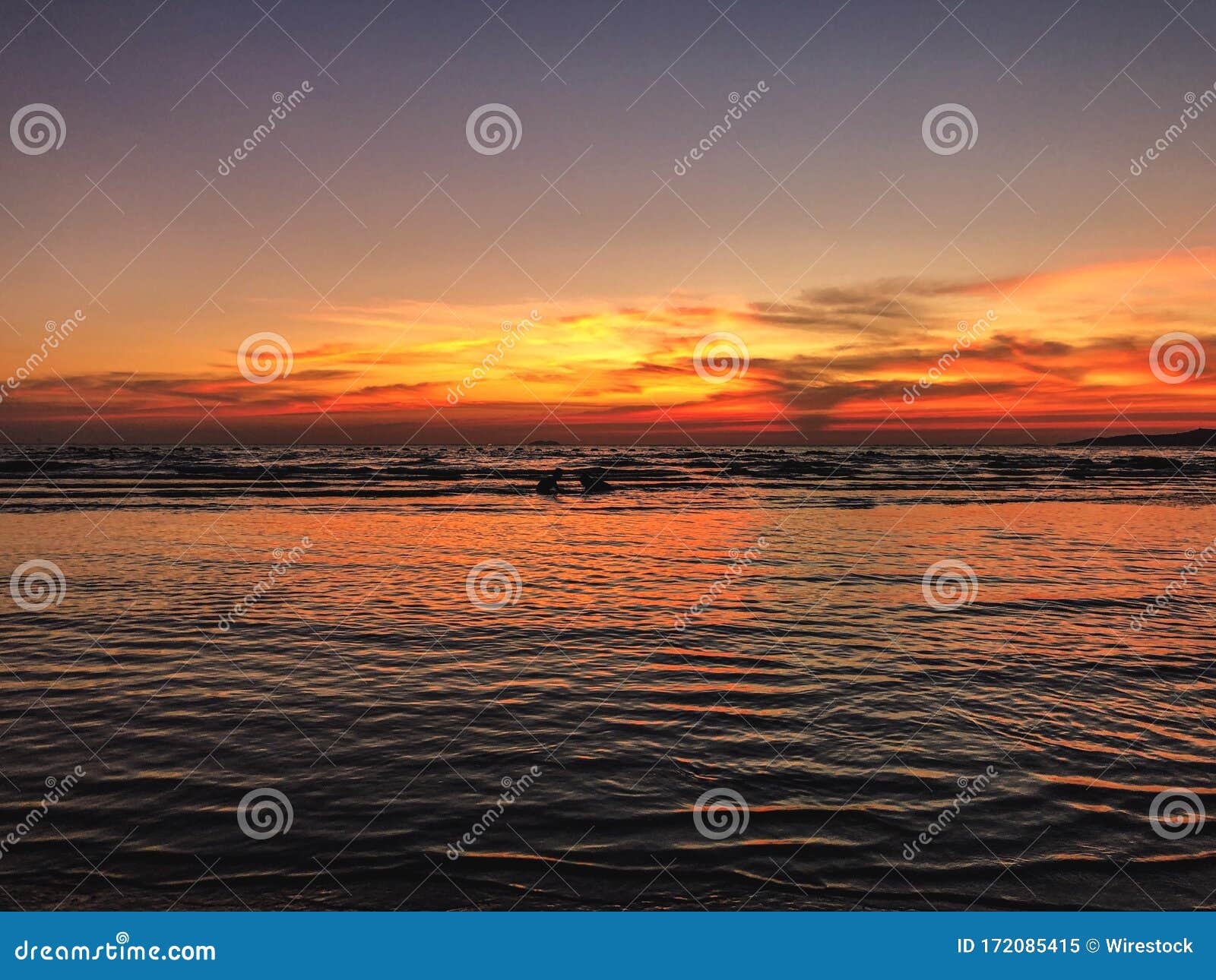 Scenery of Sunset on the Beach with Calming Waves of the Ocean Stock ...