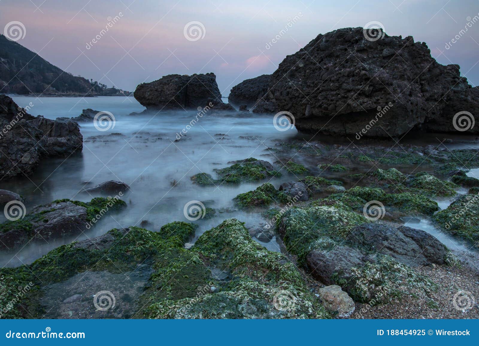 Scenery of Sunset in the Ocean with Big Rocks on a Seashore Stock Image ...