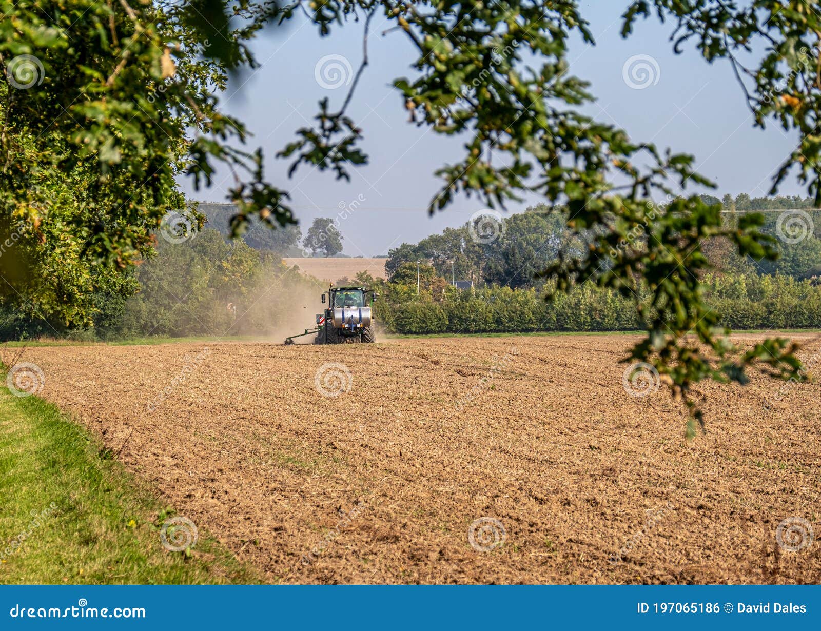 Scenic Image of a Tractor at Work in a Dusty Field. Stock Photo - Image ...