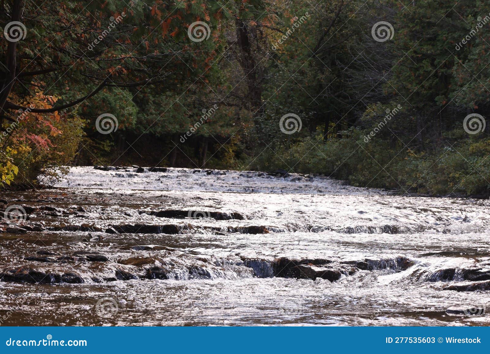 Scenic Landscape Featuring a Large Waterfall Cascading Down a Rocky ...
